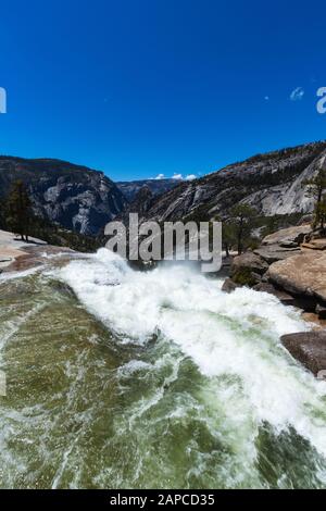 View of a huge waterfall from the rock in the background of mountains ...