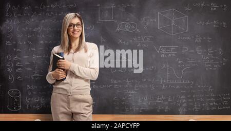 Female math teacher in front of the chalkboard Stock Photo - Alamy