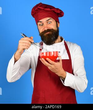 Caucasian hipster male cook with surprised face holding empty ...