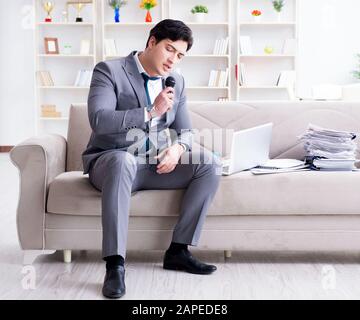 Sad businessman singing in office Stock Photo - Alamy