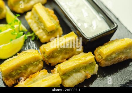 Skinless and boneless battered Alaska Pollock fillet pieces, topped ...