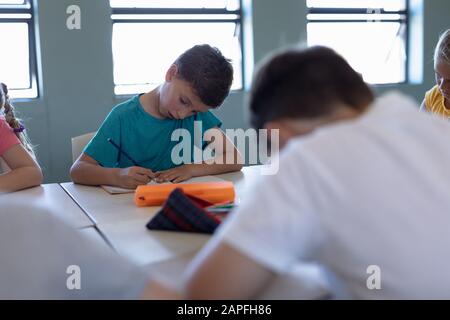 Schoolboy sitting in classroom during lesson in elementary school Stock ...