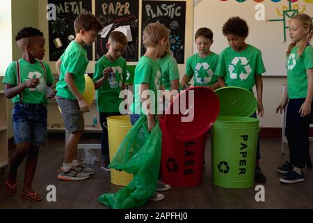 Group of people with recycling in bins Stock Photo - Alamy