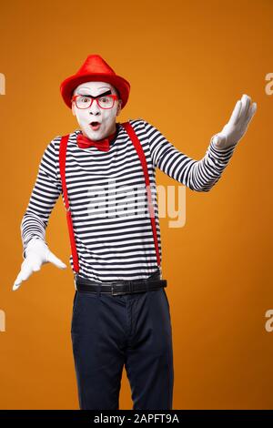 confused mime looking at camera isolated on black Stock Photo - Alamy
