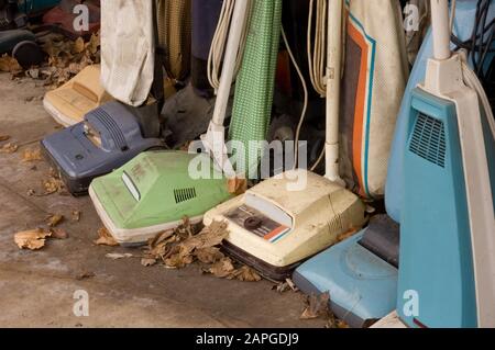 Picture of old dusty and colourful handheld vacuum cleaners surrounded ...