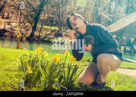 Closeup of a red fox smelling the flower marigold Stock Photo - Alamy