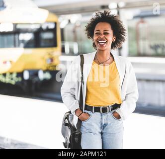 Businesswomen laughing on train platform Stock Photo - Alamy