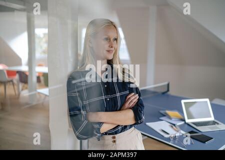 An interior shot of a room with a ping pong table, light yellow walls ...