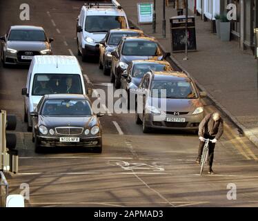 Queue of traffic waiting at the traffic lights on a rainy Putney High ...