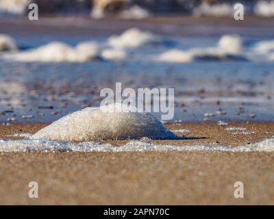 Green wave with white seafoam closeup on sandy paradise beach, Sri ...