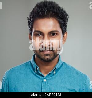 Posed portrait of a Hindu young man in blue dressed as the God Shiva at ...