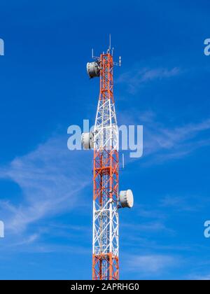 Vertical shot of a telecommunication tower under the clear blue sky ...