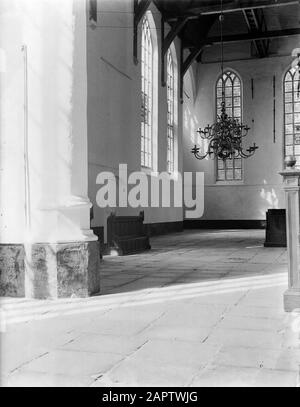Interior of the Grote Kerk in Edam: benches, windows and a chandelier ...