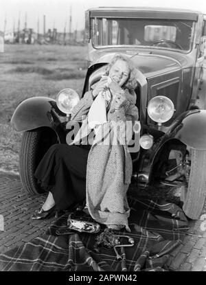 Model Eva Waldschmidt sits on the beach and clutches a beach ball to ...