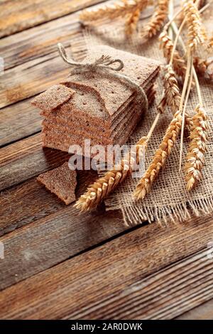 Rye crackers and ears on a old wooden table. Healthy organic food Stock ...