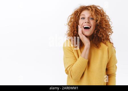 glad redhead girl with curly hair on blue background Stock Photo - Alamy