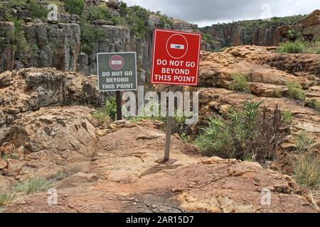 Rock formation and access restriction signs at Burke's Luck Potholes ...