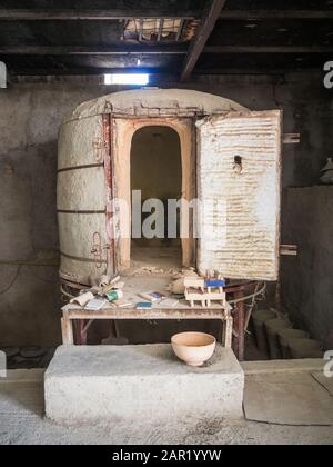 FEZ, MOROCCO - Jun 05, 2018: Moroccan workers cutting ceramic pieces in ...