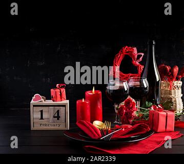 Table setting for Valentine's Day with hearts on dark wooden background ...