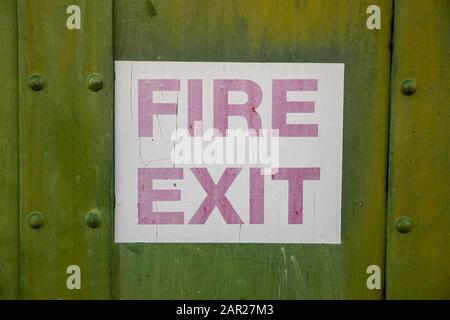 Fire against emergency exit sign Stock Photo - Alamy