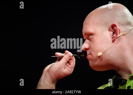 Michael van Gerwen throws a dart during his match against Chris Dobey ...