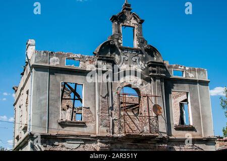 Old burnt and destroyed countryside house closeup in clear sunny day ...