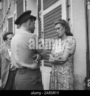 Land Traitors in France Woman takes clothes out of a suitcase under the ...