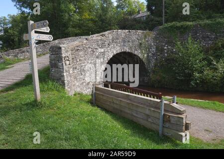Brecon and Monmouth Canal at Talybont on Usk with canal bridge and man ...