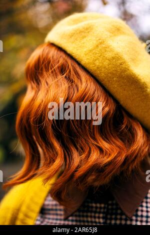 Woman with curly red hair, nature photographer with camera hiking in ...