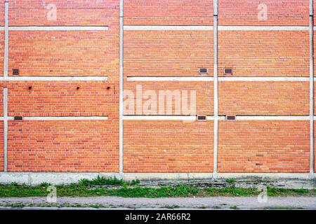 Red lined brick wall background with green grass Stock Photo - Alamy
