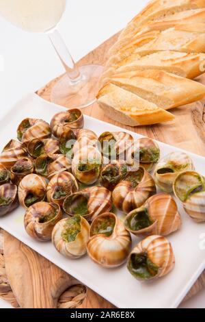Grilled edible snails with a garlic, butter and parsley sauce, bought ...