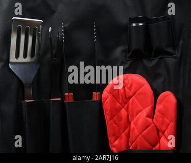 BBQ instruments kit - tongs, spatula, fork - close up isolated on green ...