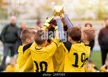 Kids celebrating sports success. Victory of children football team in ...