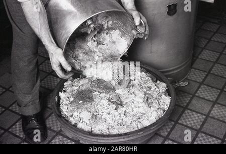 1950s, historical, making mead, crystallized raw honey in a metal ...