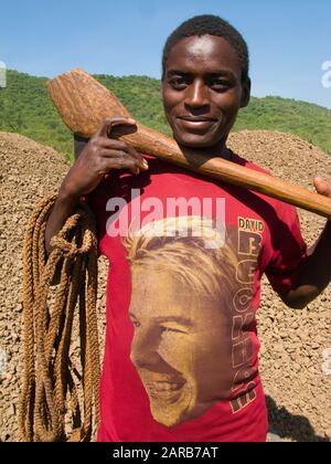 Young man from Konso tribe holding African tribal axe, Omo Region ...