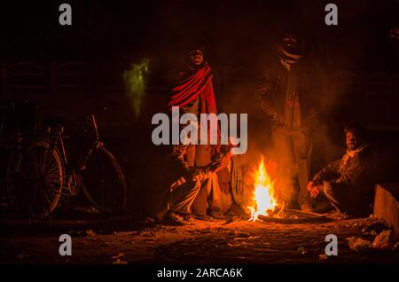Security guards surrounding the Taj Mahal area, warming at a bonfire ...