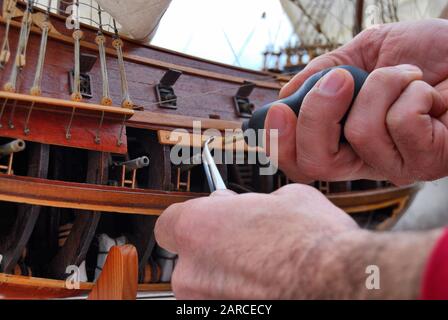 Young man constructing a ship model in a ship-modelling studio Stock ...