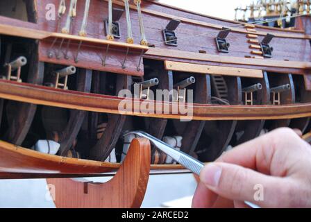 Young man constructing a ship model in a ship-modelling studio Stock ...