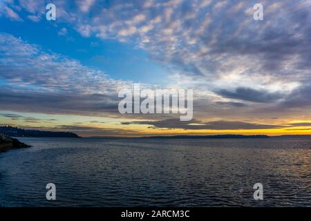 An overcast cloudy sunset over the Puget Sound in West Seattle ...