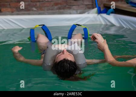 Pregnant woman exercising in a swimming pool Stock Photo - Alamy