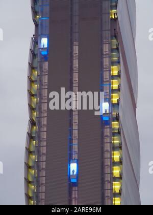 Moving outdoor glass elevators of a modern building Stock Photo - Alamy