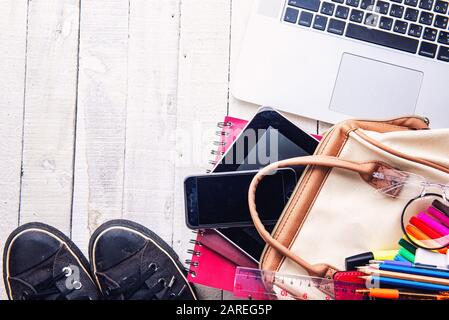 backpack glasses and sneakers on wooden background Stock Photo - Alamy