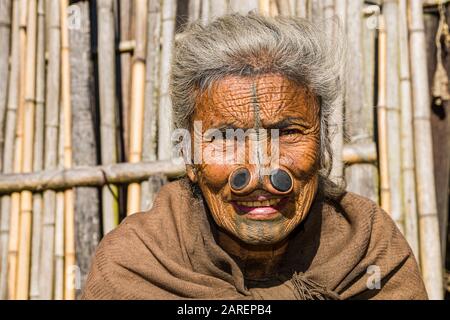 Apatani tribal woman with traditional yaping hullo (nose plugs) and ...