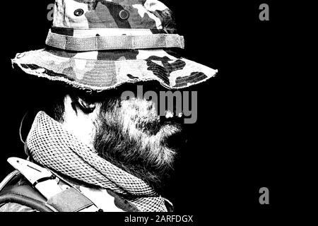 Bearded commando soldier with camouflage face paint, wearing a tactical ...