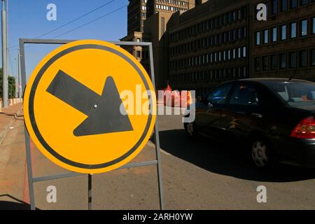 Roadworks and road worker regulating traffic with road traffic safety ...