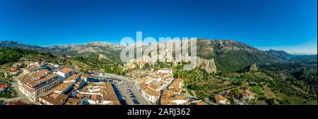 A beautiful aerial view of Guadalest Reservoir with green mountains and ...