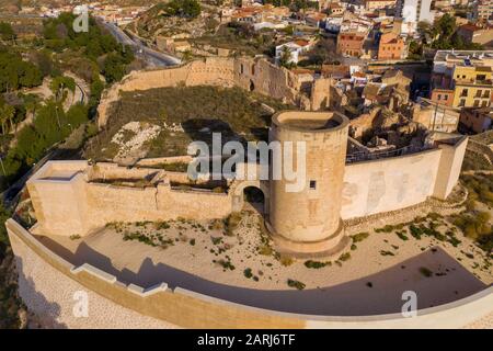 Aerial panoramic view of medieval Elda castle above the town with ...