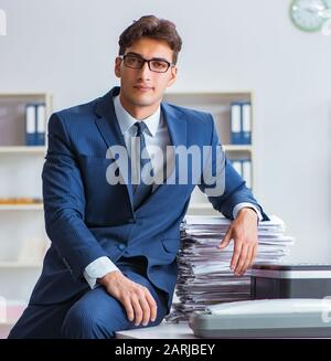 Businessman making copies in copying machine Stock Photo - Alamy