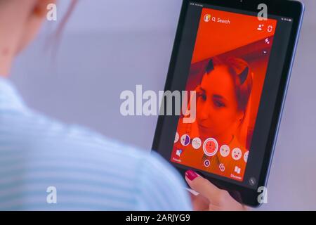 Snapchat multimedia messager with 3d face mask filter on tablet Stock ...