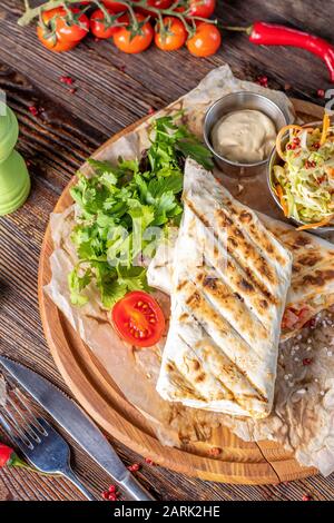 Shawarma dish served on wooden table with close up and top view also ...